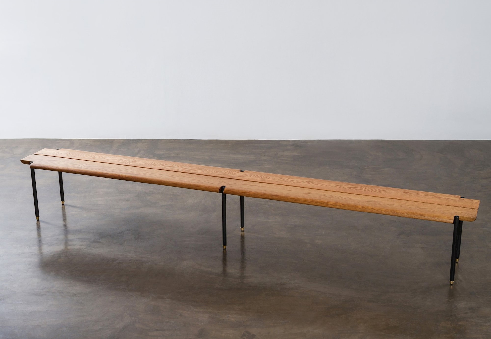 STACKING BENCH IN HARD FUMED WOOD SEAT AND MATTE BLACK LEGS 118"